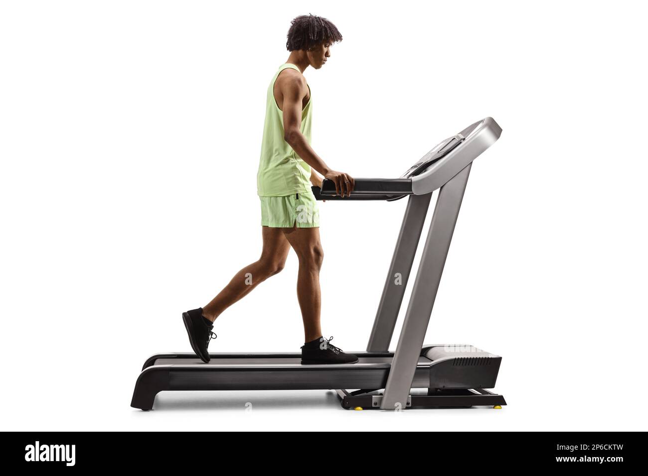 Full length profile shot of an african american guy on a treadmill ...