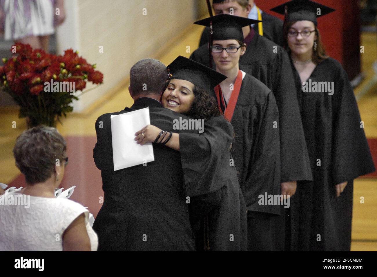 Katelyn Hattery hugs principal Tim Garland after receiving her diploma ...