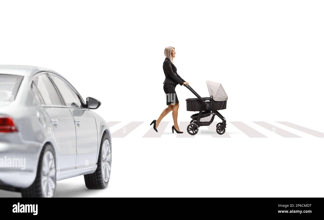 Full length profile shot of a businesswoman pushing a pushchair on a ...
