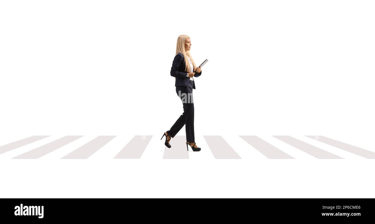 Full length profile shot of a young businesswoman holding documents and ...