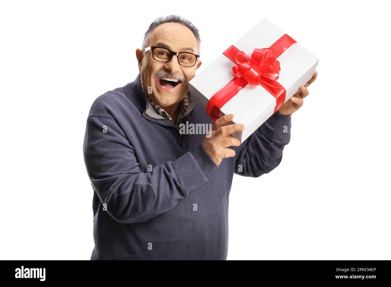 Happy mature man showing a gift box with red ribbon isolated on white ...