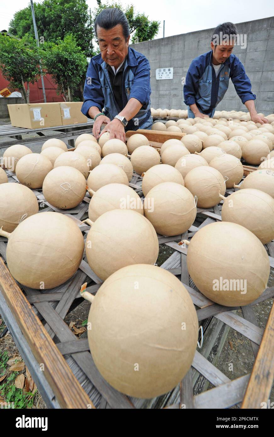 Firework shells measuring 12 centimeters in diameter dry under the sun ...