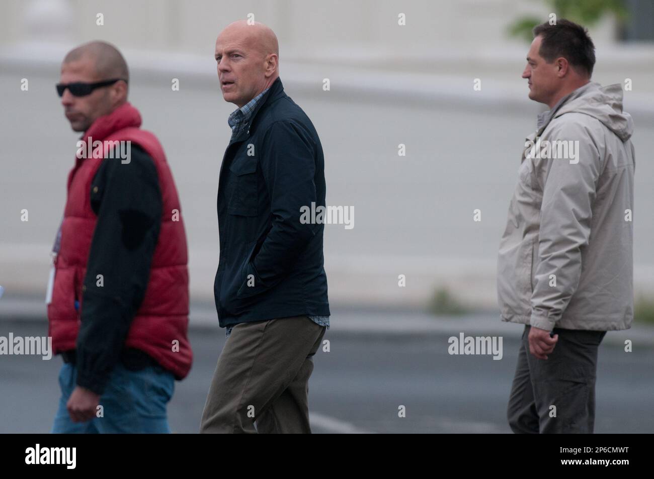 US actor Bruce Willis, center, arrives at the set in Budapest, Hungary ...