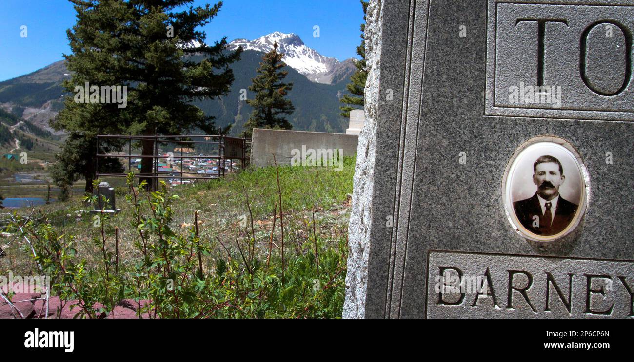 In this May 29, 2012 photo, a photograph adorns the headstone marking ...