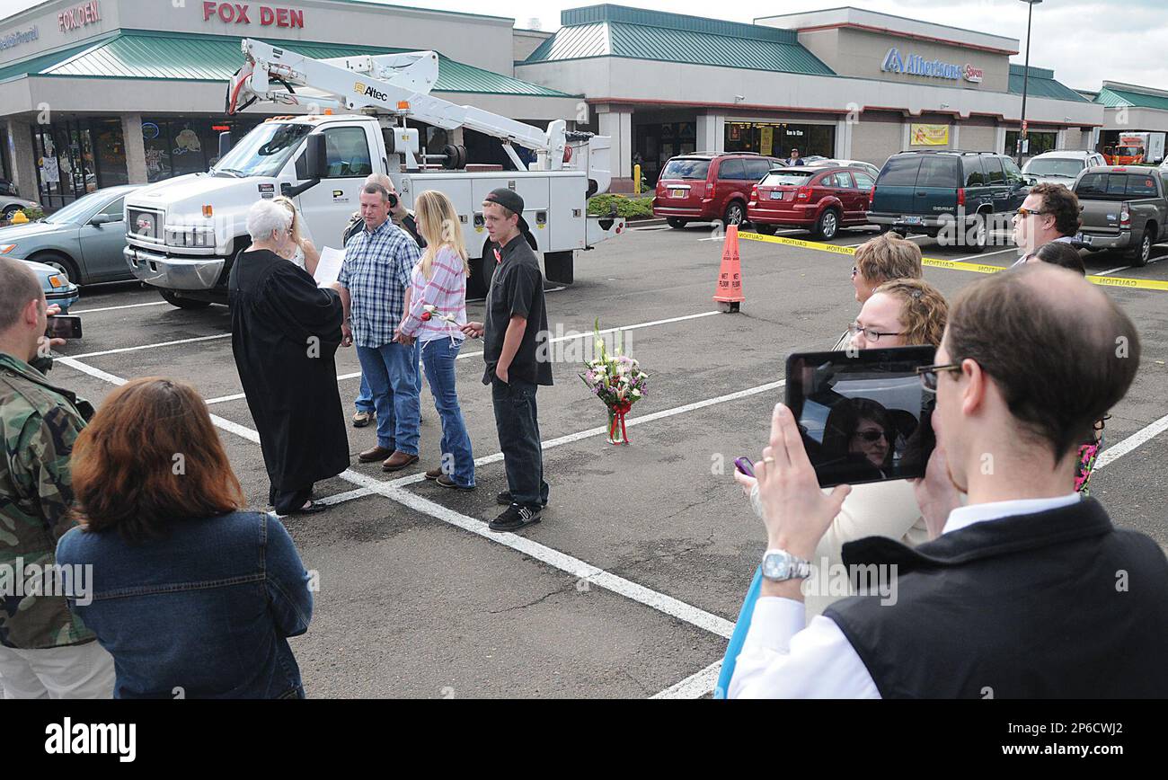 Family members and passerbys watch as Scio, Ore., Municipal Judge ...