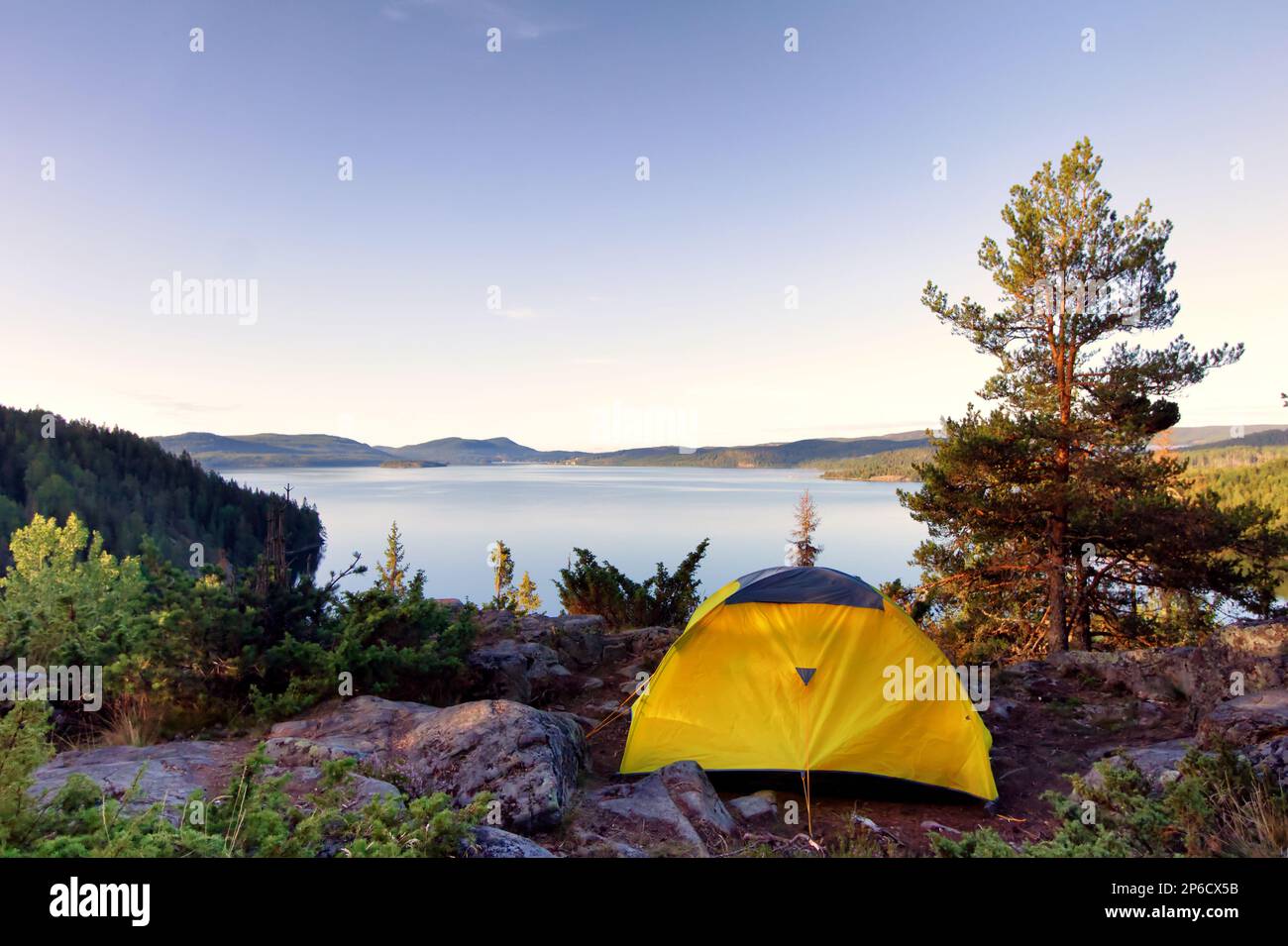 Tent in the Swedish wilderness with scenic view over lake, mountains ...