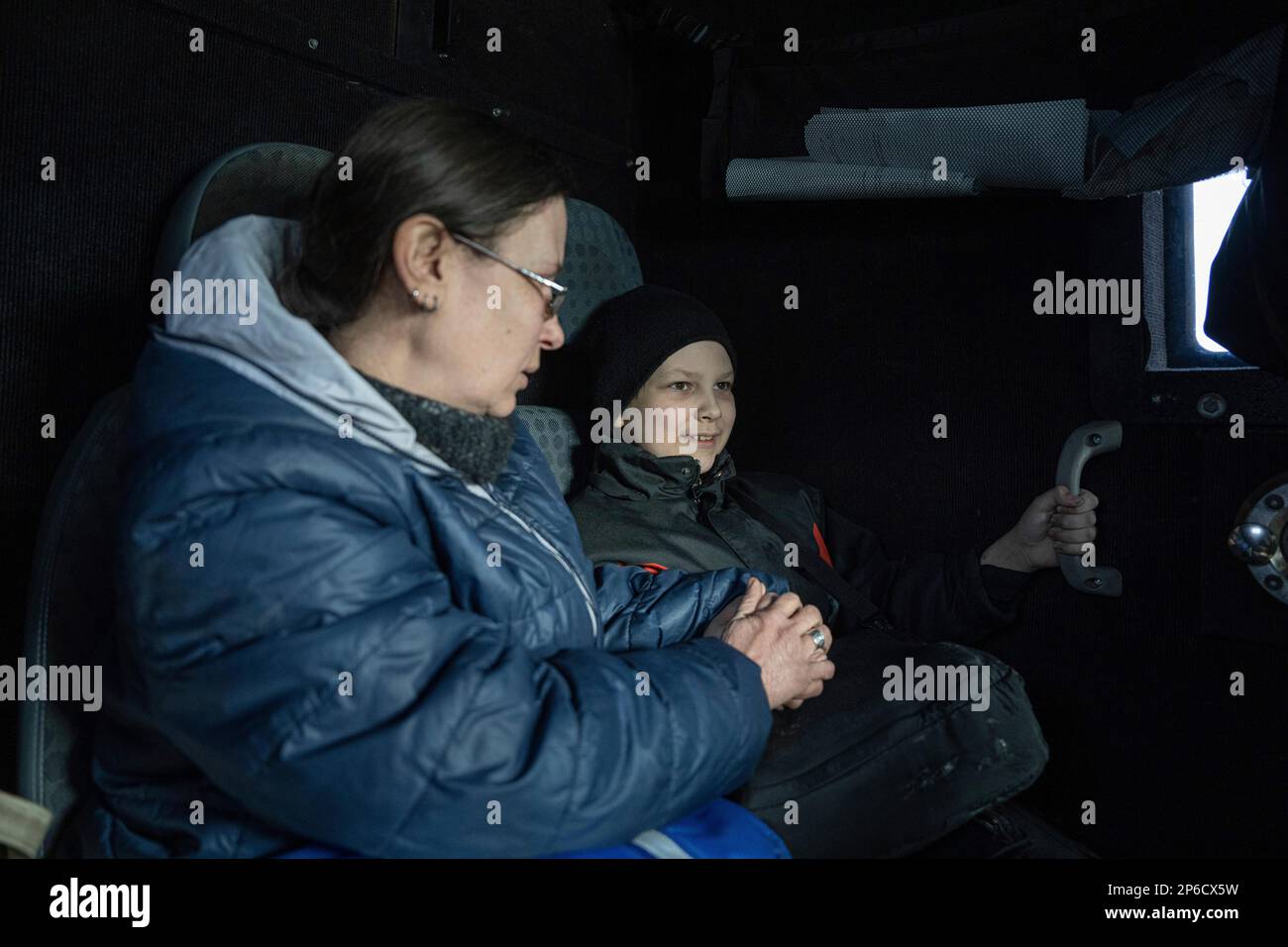 Olga Shulga with her son Myroslav ride in the car during an evacuation ...