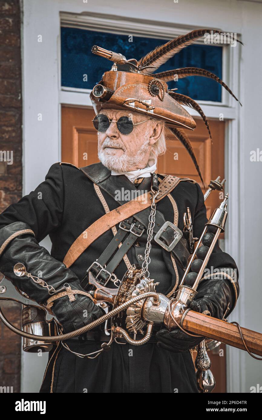Portrait of a retro futuristic steampunk pirate holding a weapon ...