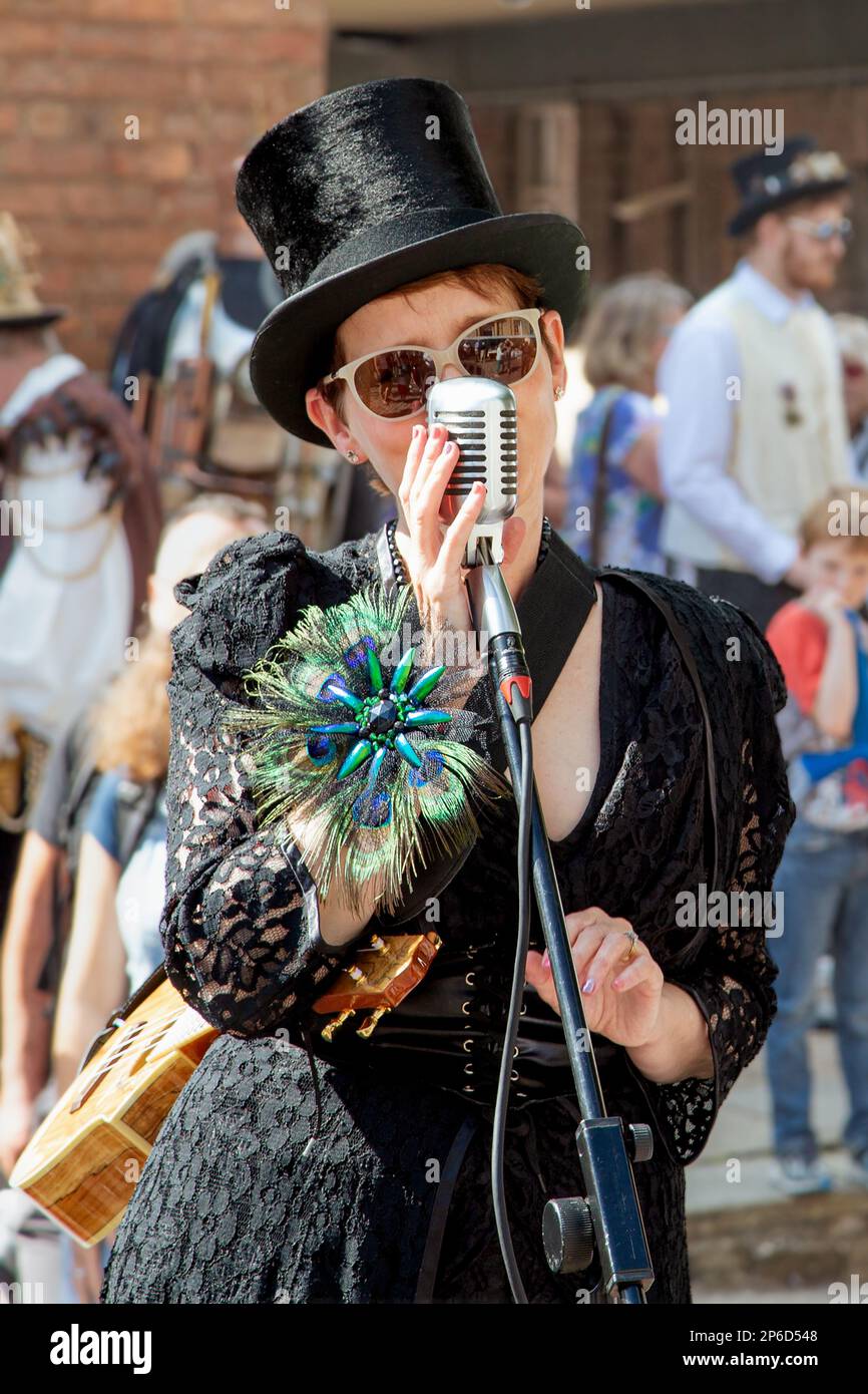 A woman singing at a festival. Female vocalist, performer at an outdoor ...