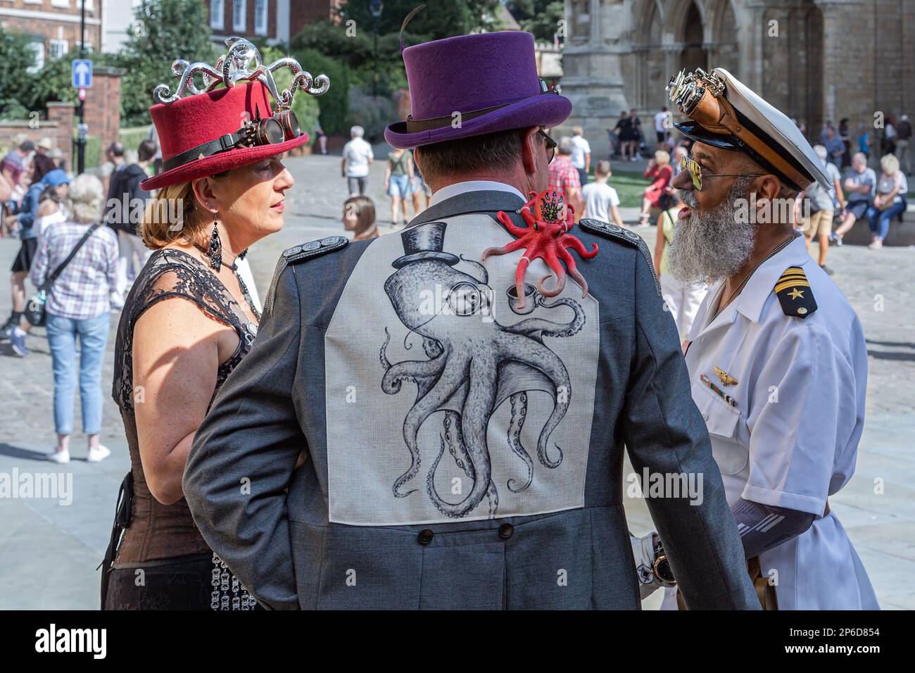 A group of friends enjoying a conversation at a steampunk event Stock ...