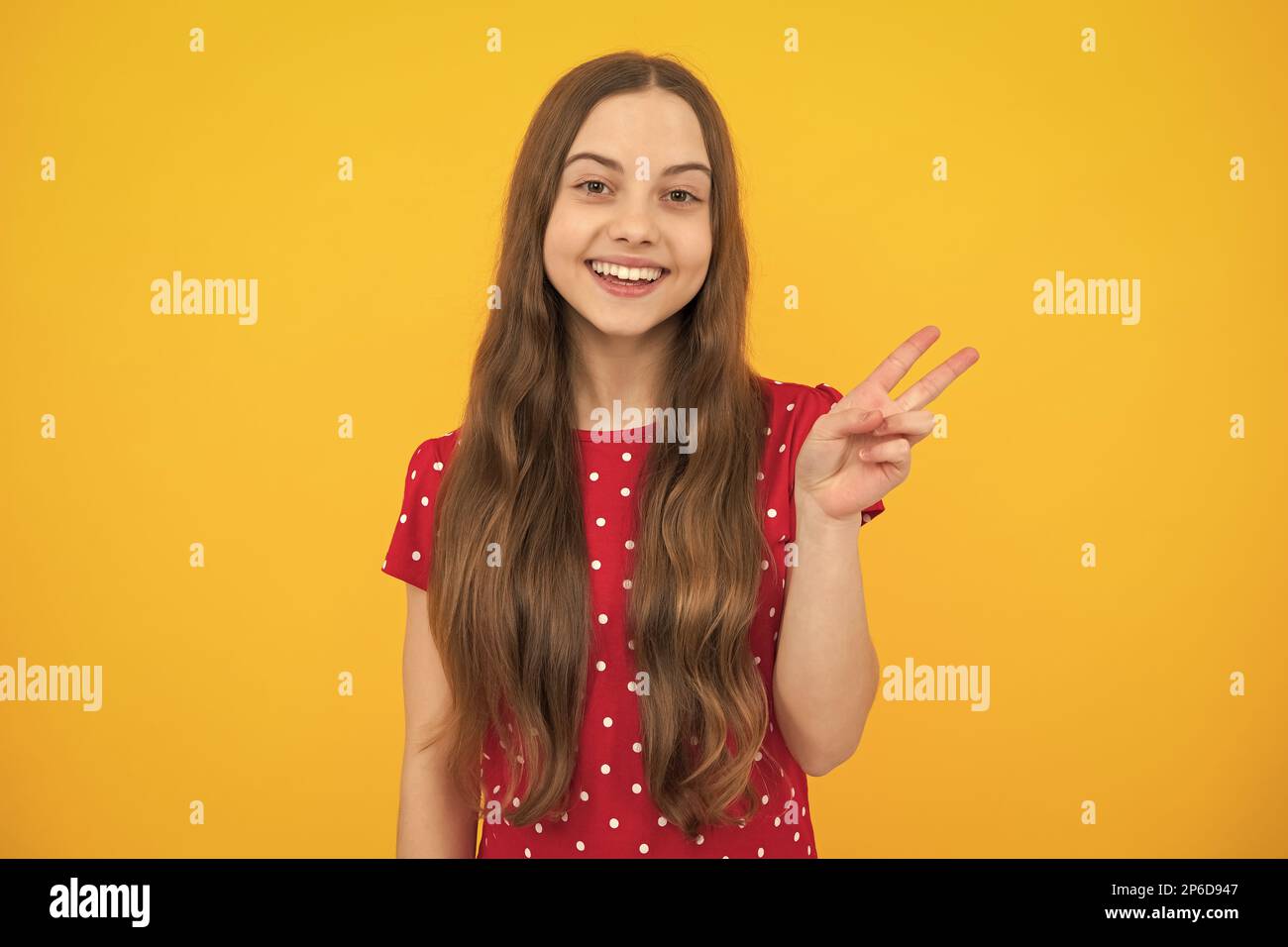 Cheaky teen girl giving victory sign. Happy teenager child smiling with ...