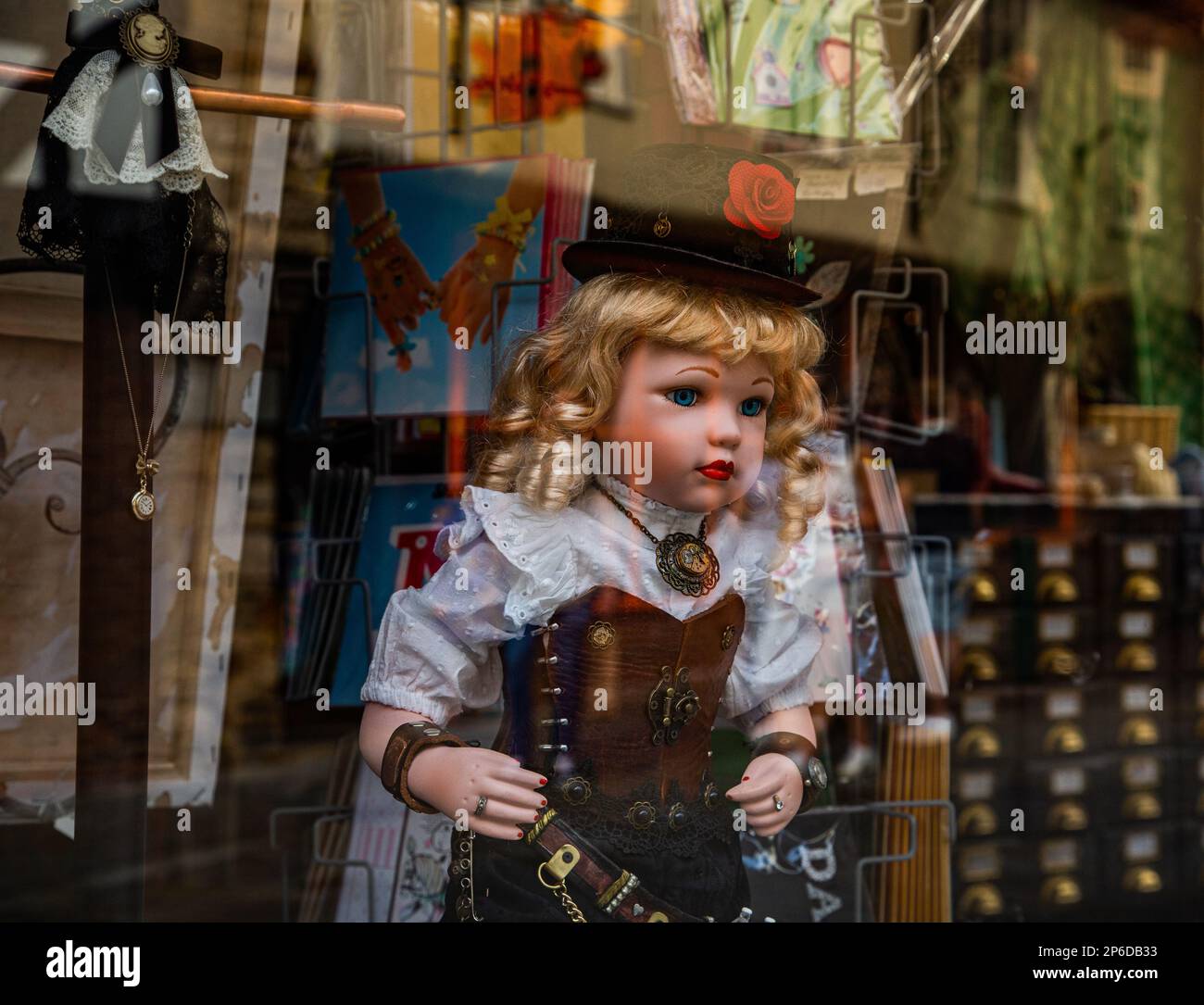 A steampunk inspired doll looking out from a shop window Stock Photo ...