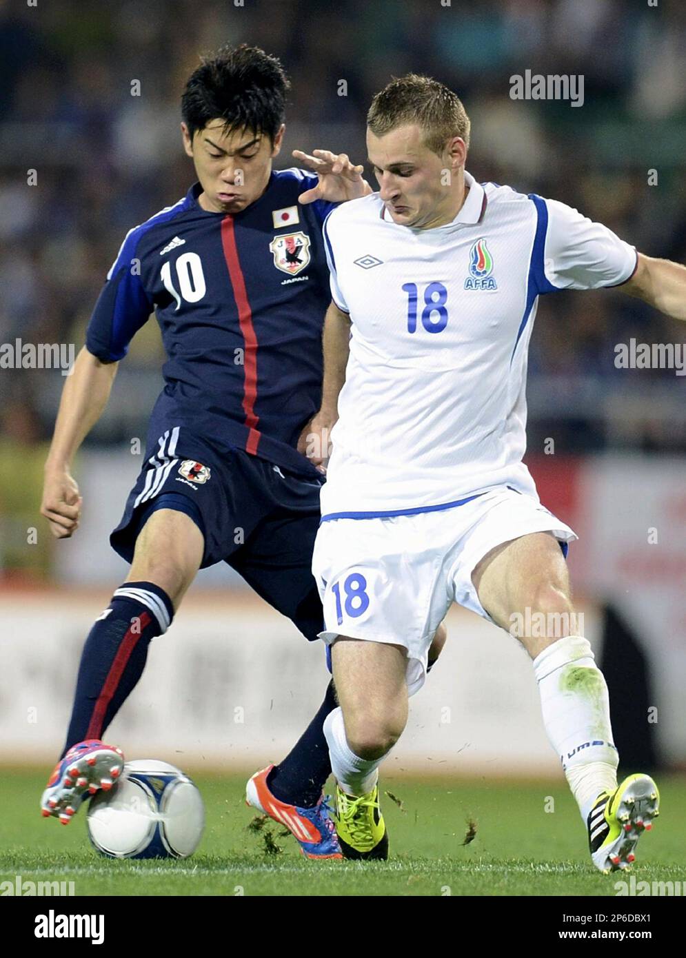 Japan's Shinji Kagawa (L) dribbles a ball in the first half of the ...