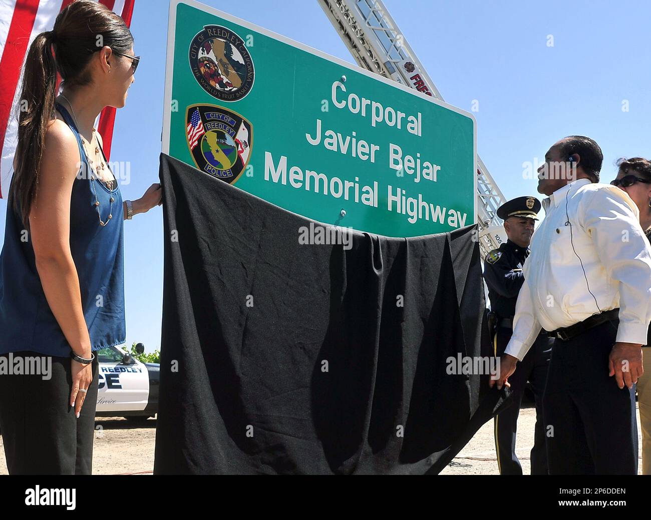 A highway sign honoring Reedley Police Cpl. Javier Bejar is unveiled by ...
