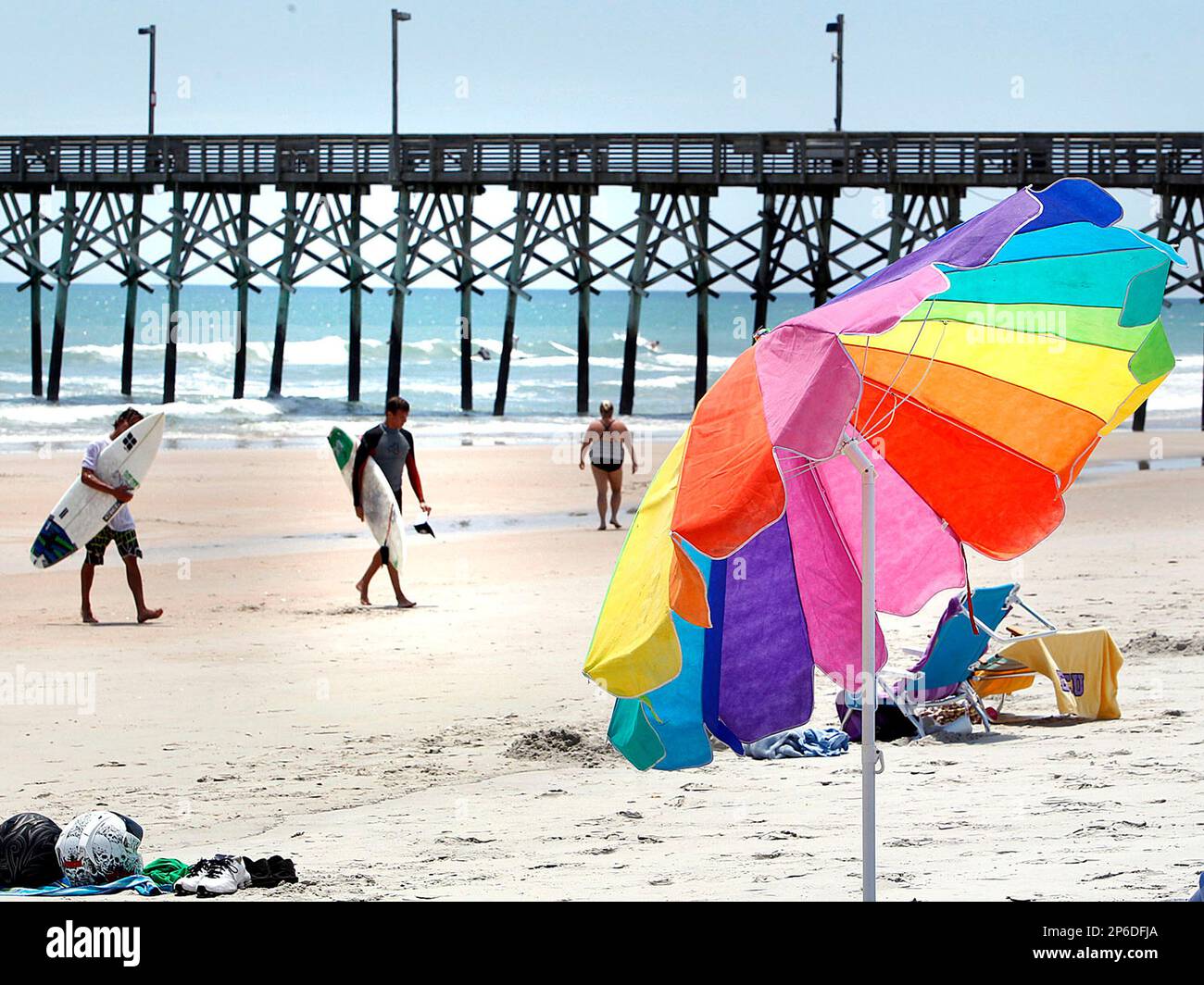 In this photo taken Monday, May 21, 2012, surfers and sun lovers enjoy ...