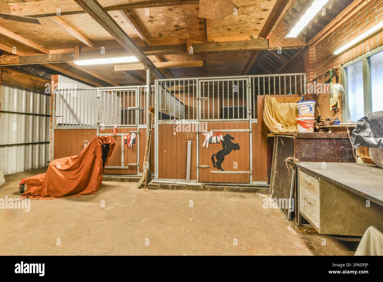 the inside of a horse barn with two stalls and one stall that is ...