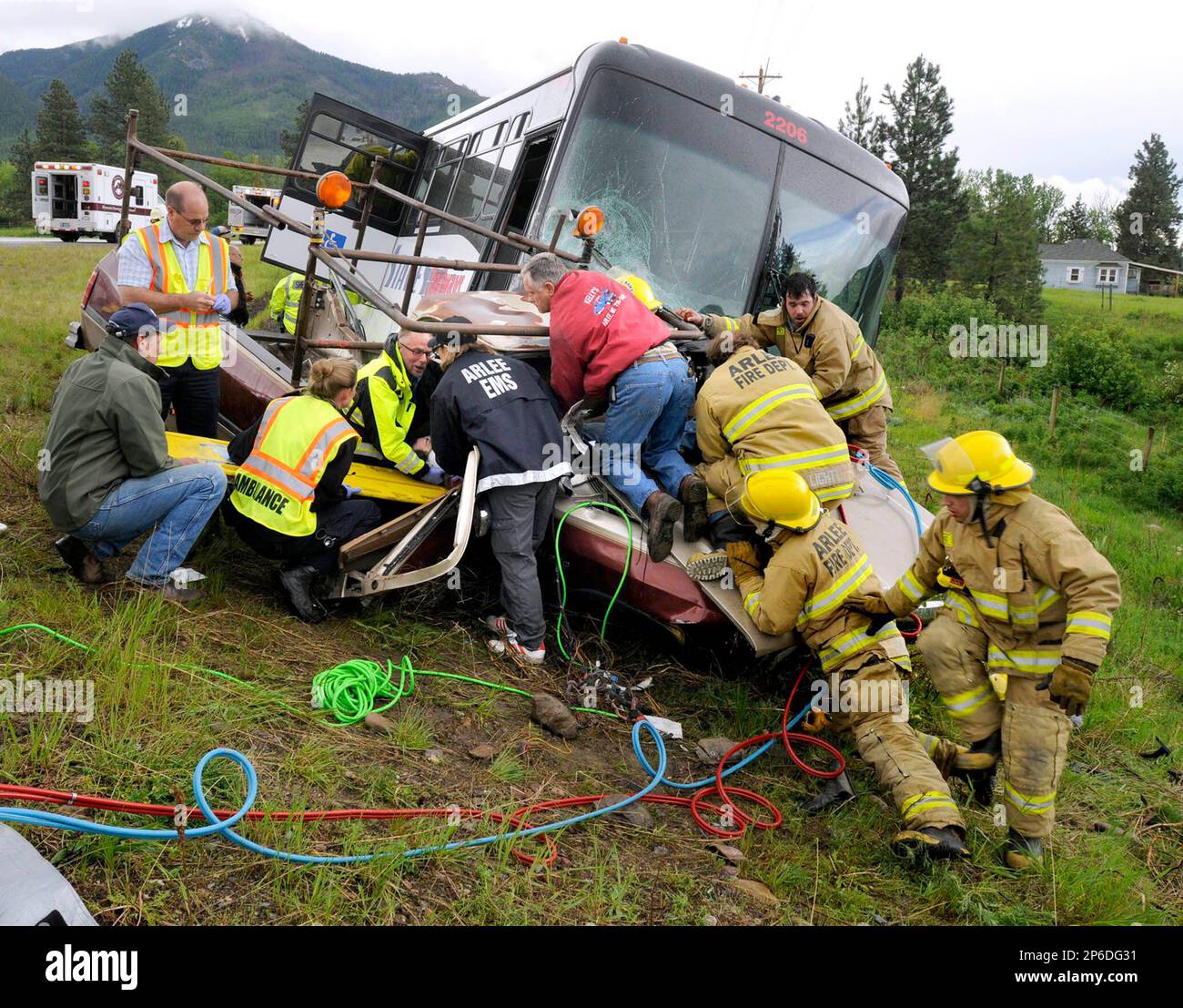 Emergency personnel work to extricate a driver trapped in a truck after ...
