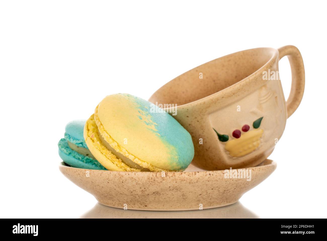 Two confectionery products, sweet macaroons on a ceramic saucer with a ...