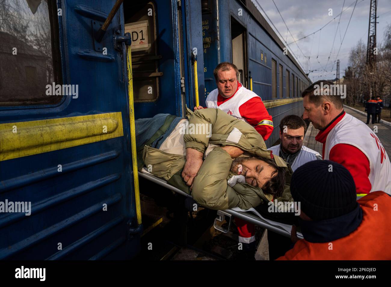 MSF workers carry a man on a stretcher into a MSF medical train that ...