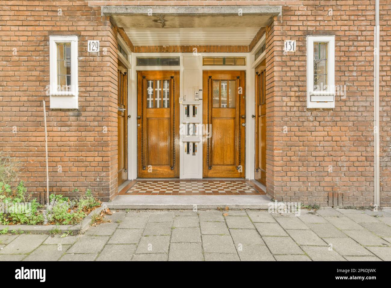 a brick building with two doors on each side and one door open to the ...
