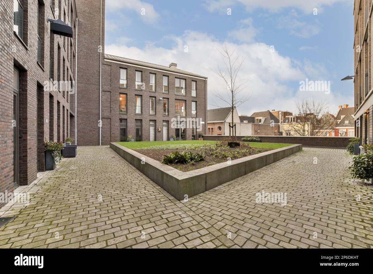 a courtyard in the middle of an urban area with brick buildings and ...
