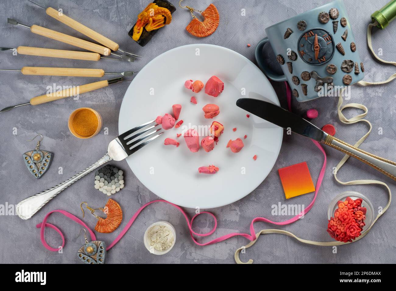 Top view on polymer clay master workplace. pink, grey, red modelling ...