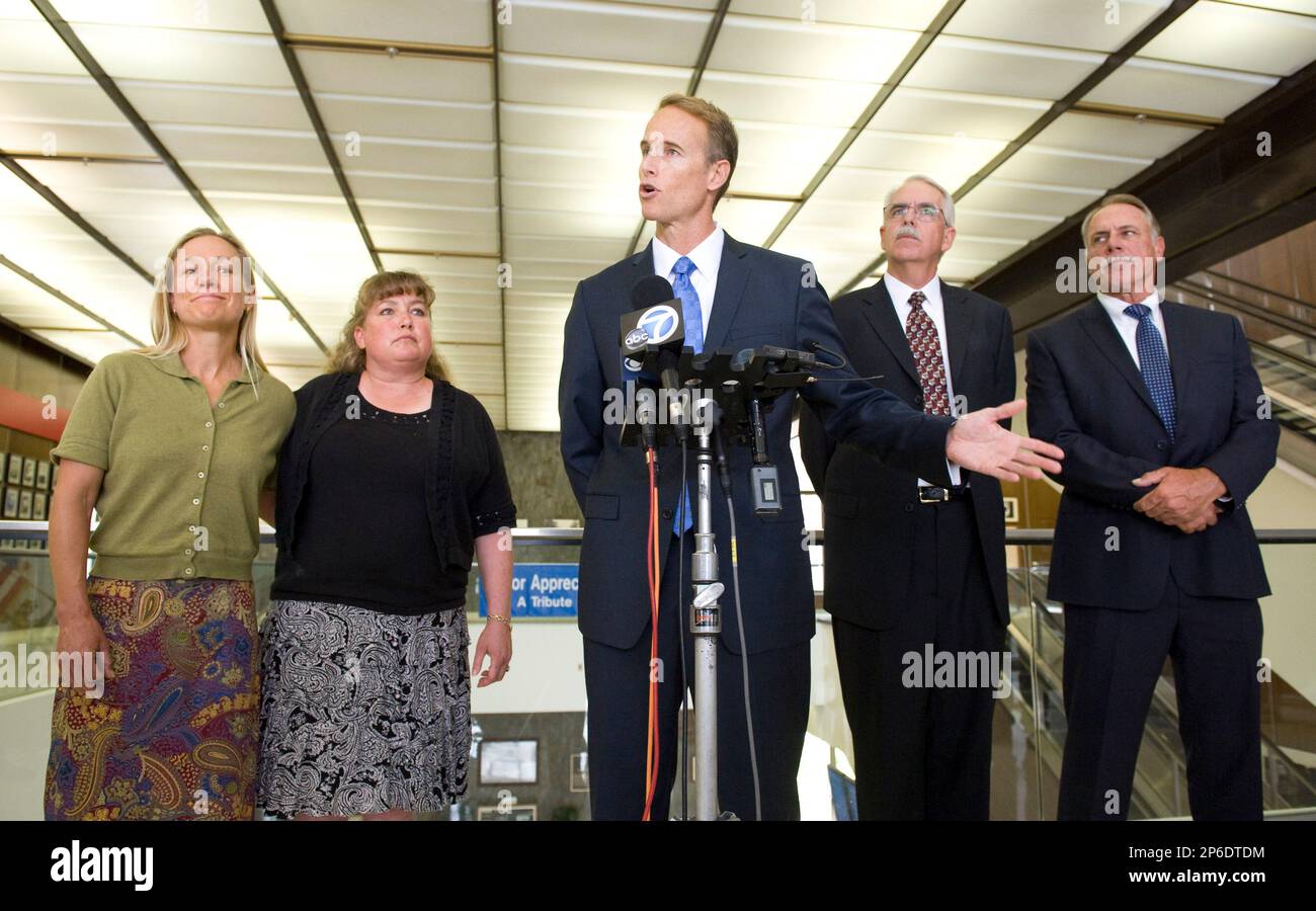 Deputy District Attorney Matt Murphy, center, holds a news conference ...