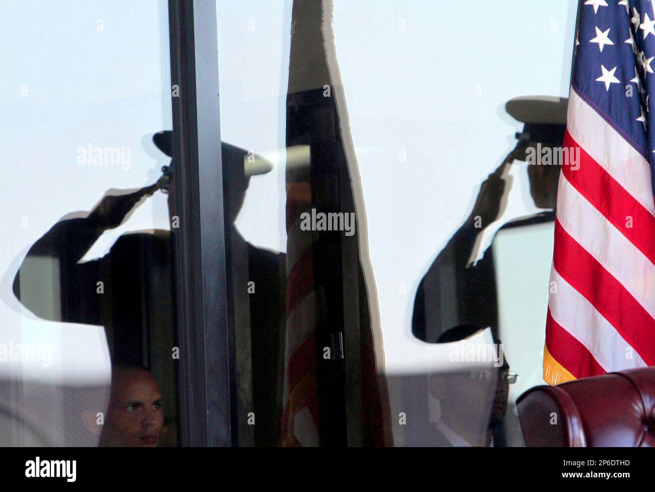 The reflection of Brig. Gen. Andrew Mueller, left, and Brig. Gen ...