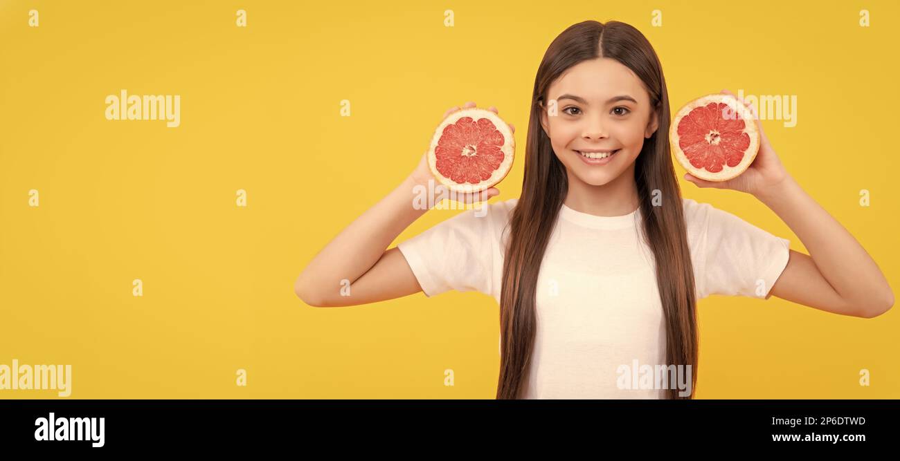 glad teen girl with grapefruit. vitamin and dieting. child eating ...