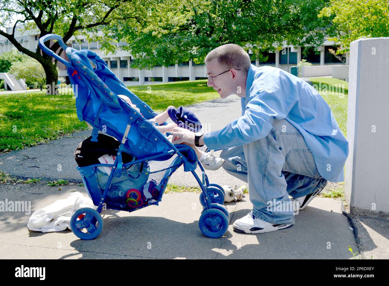Jeremy Spradlin plays with his 9-month-old son, Gabriel, while waiting ...