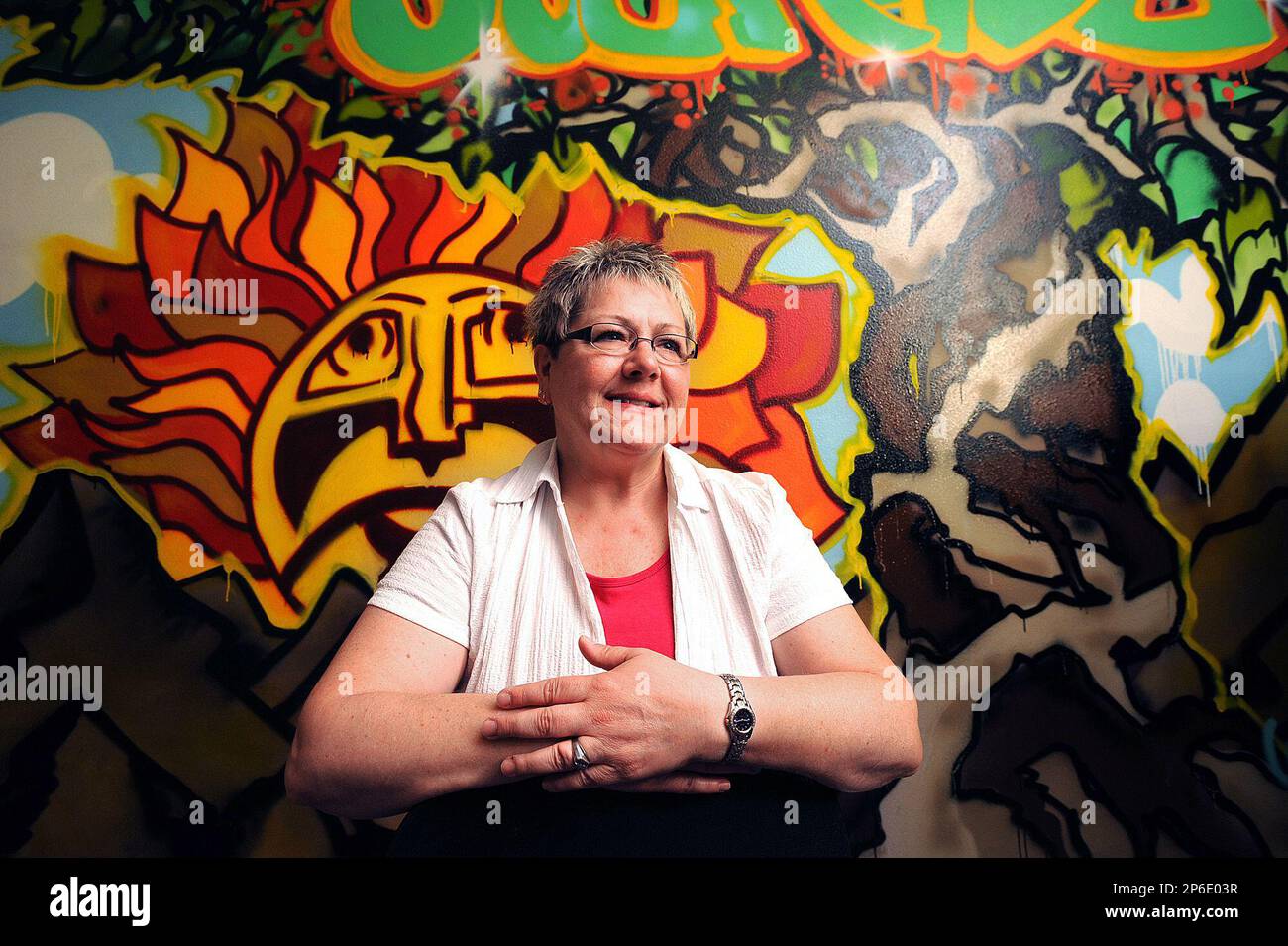 This May 14, 2012, photo shows Nancy O'Keefe in front of a mural ...