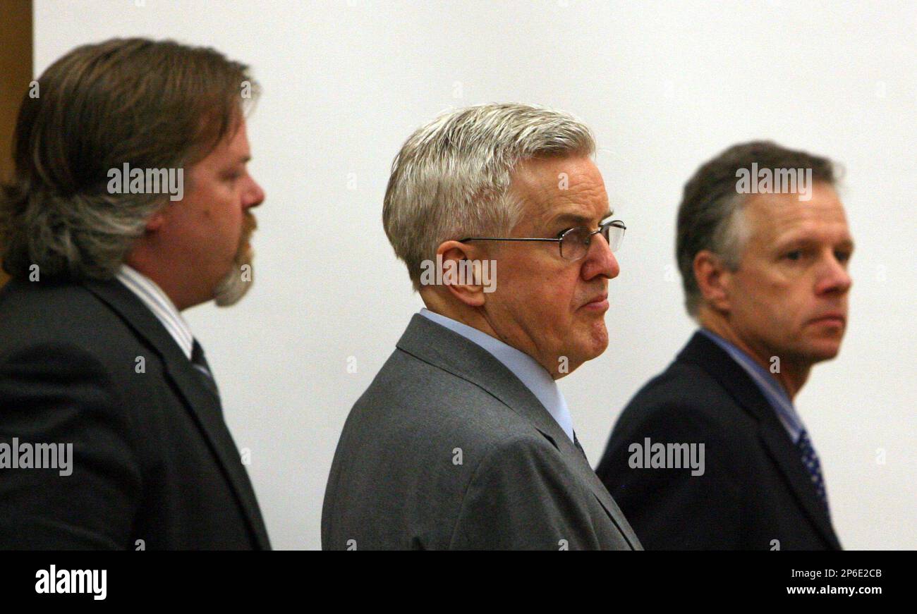 Steve Powell, center, stands with his attorneys Travis Currie and Mark ...