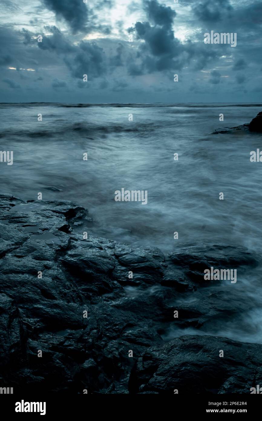 Cloudy evening during blue hour with seas shore and waves Stock Photo ...