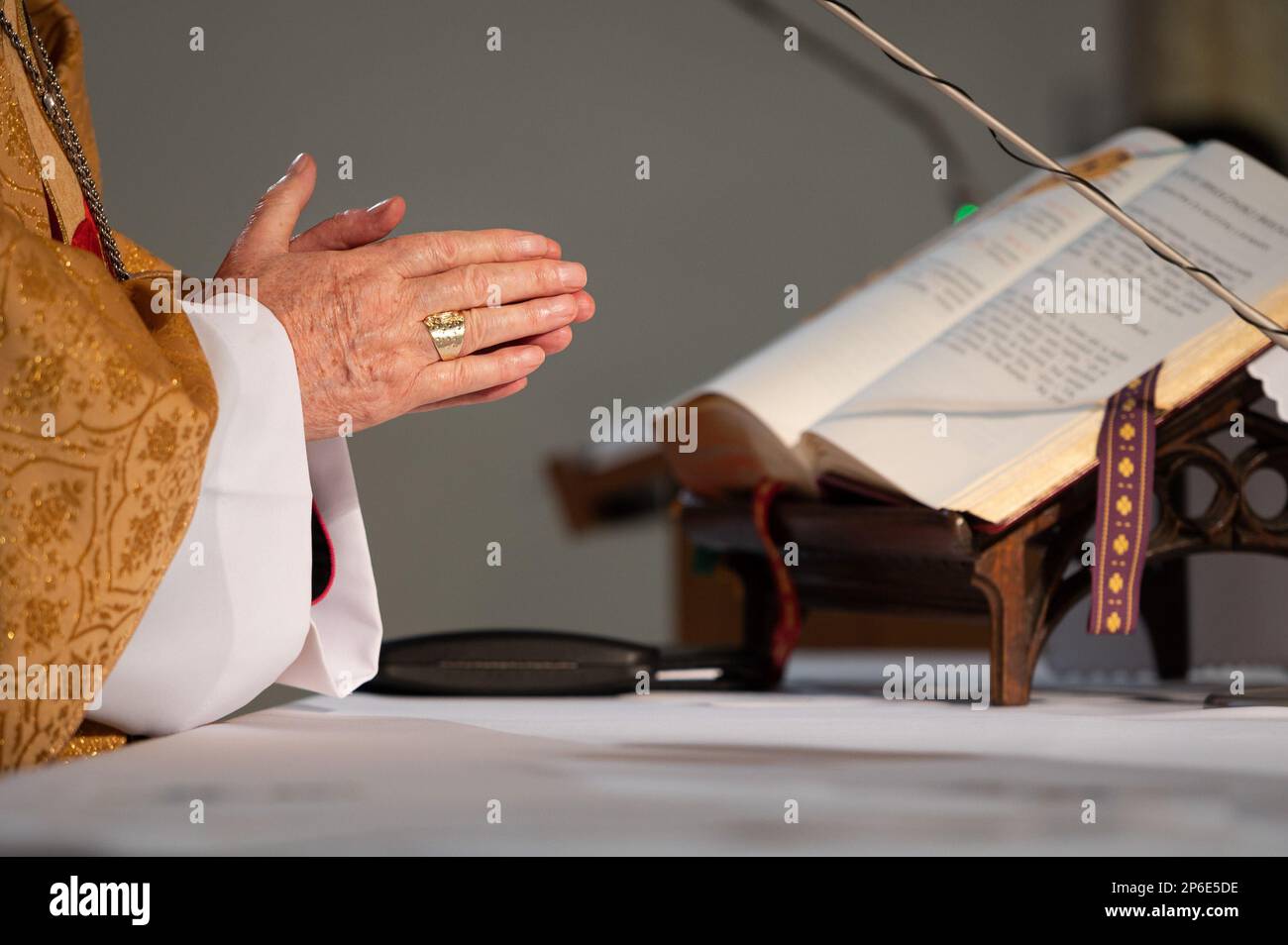 hands of the bishop with a ring on the finger in the background of the ...