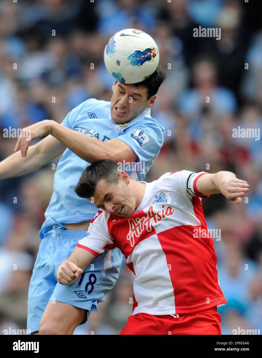 Gareth Barry of Manchester City tussles with Joey Barton of QPR ...