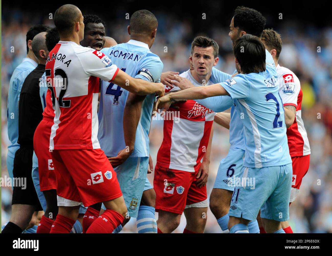 Joey Barton of QPR is held back from Vincent Kompany of Manchester City ...