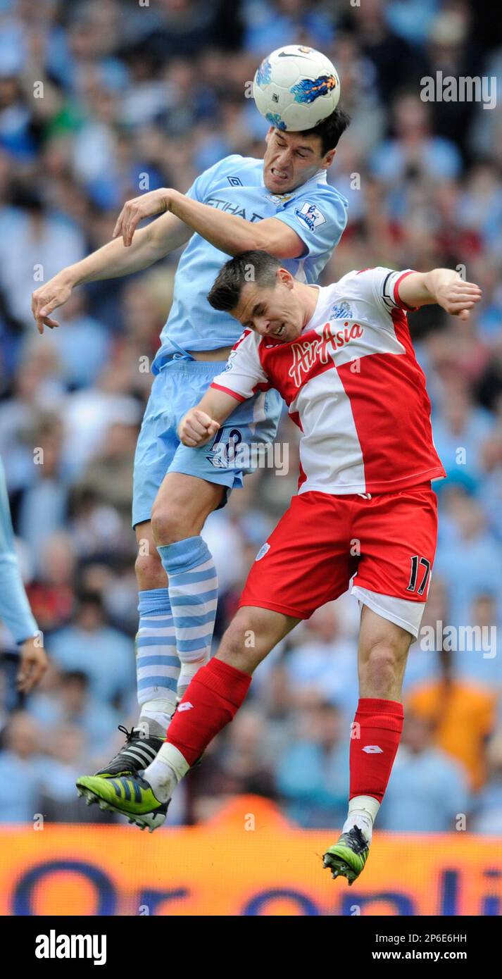 Gareth Barry of Manchester City tussles with Joey Barton of QPR ...