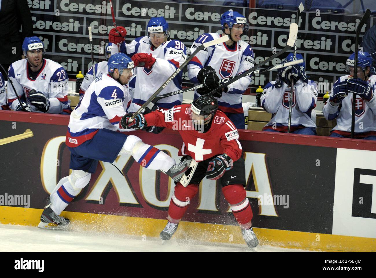 Slovakia's Michal Sersen, left, checks Switzerland's Benjamin Pluss ...