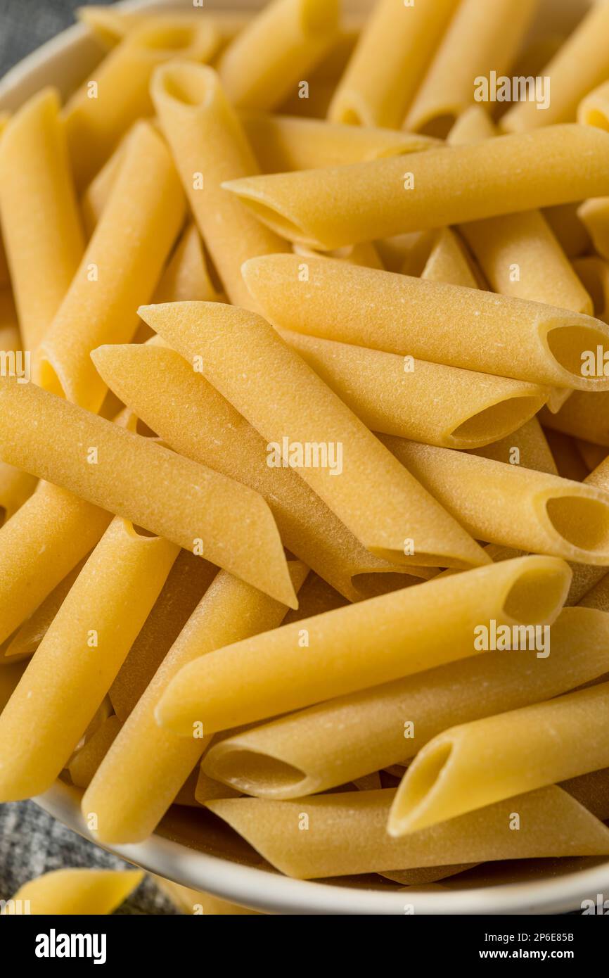 Raw Dry Mostaccioli Penne Lisce Pasta in a Bowl Stock Photo - Alamy