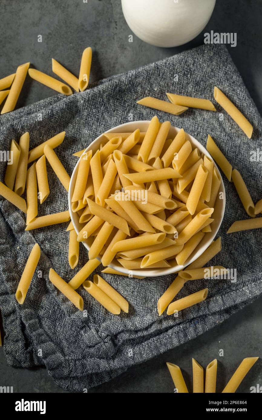 Raw Dry Mostaccioli Penne Lisce Pasta in a Bowl Stock Photo - Alamy