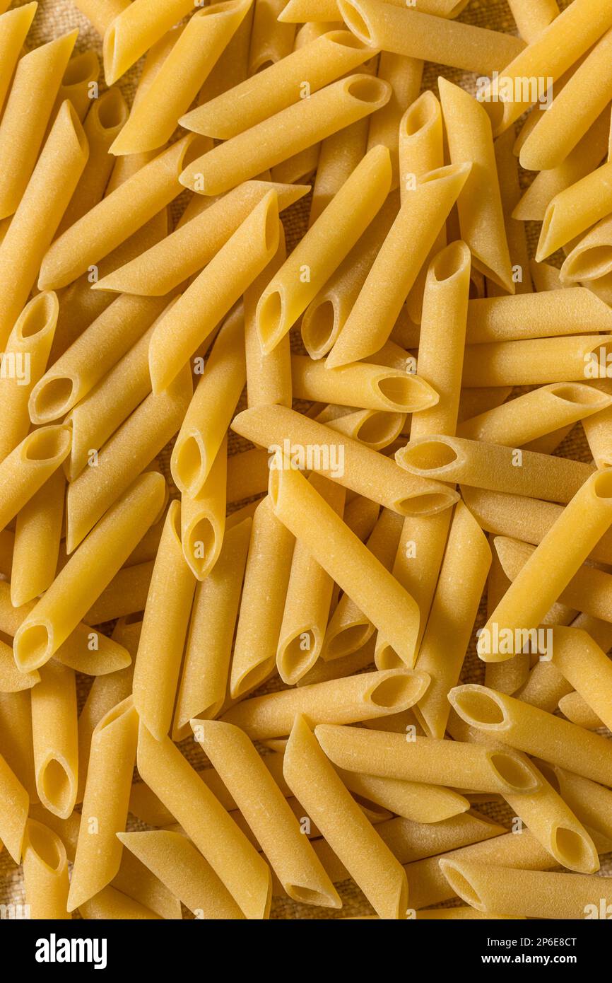 Raw Dry Mostaccioli Penne Lisce Pasta in a Bowl Stock Photo - Alamy