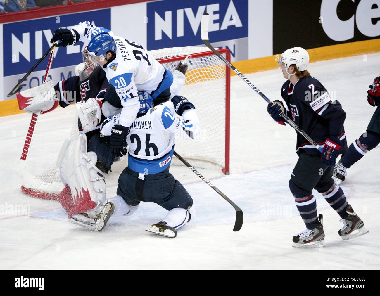 USA's Jeff Petry, right, looks on while Finland's Janne Pesonen, top ...