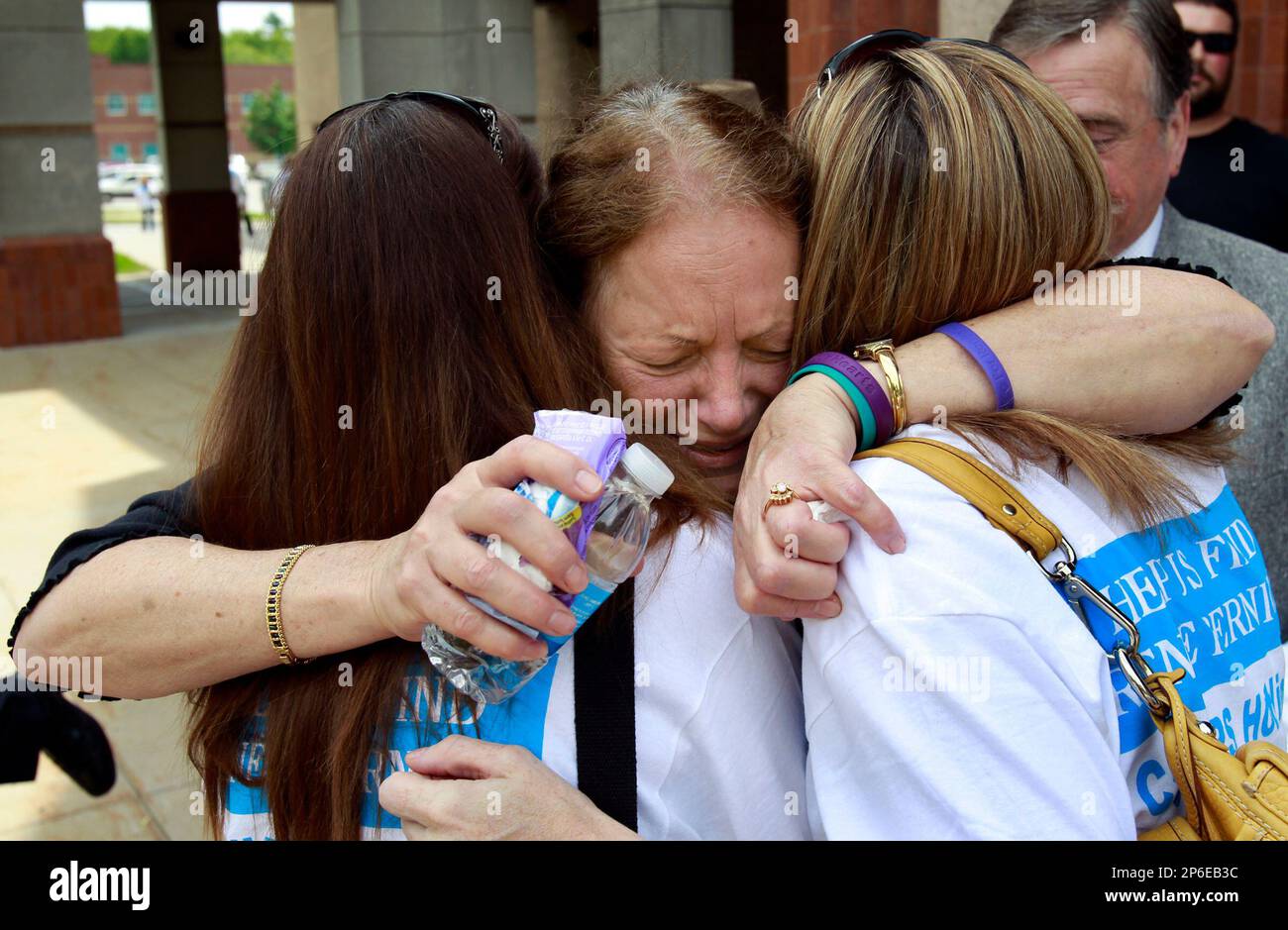 Linda Lockwood, center, the mother of Renee Pernice, is comforted by ...