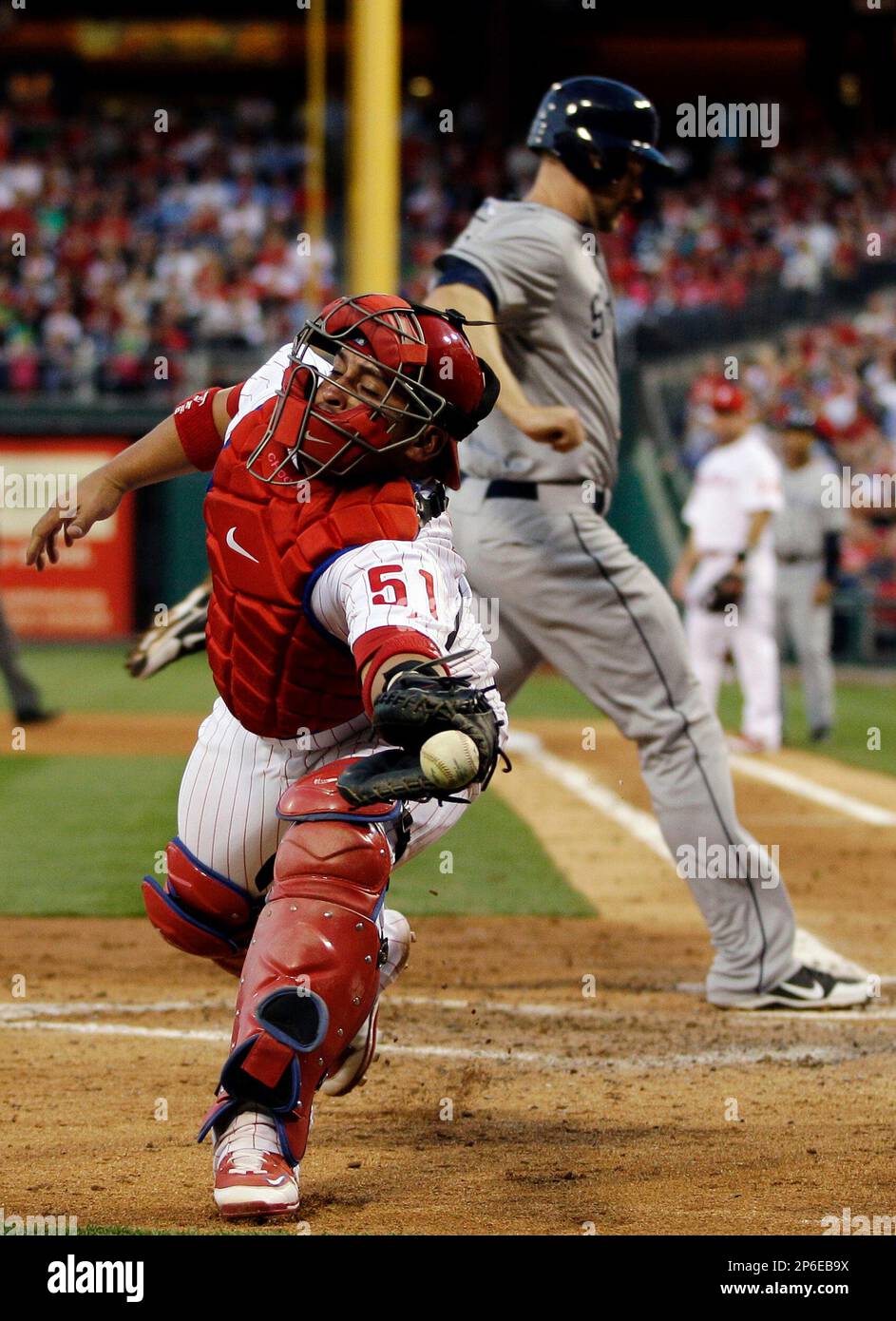 Philadelphia Phillies catcher Carlos Ruiz, left, lunges for the ball as ...