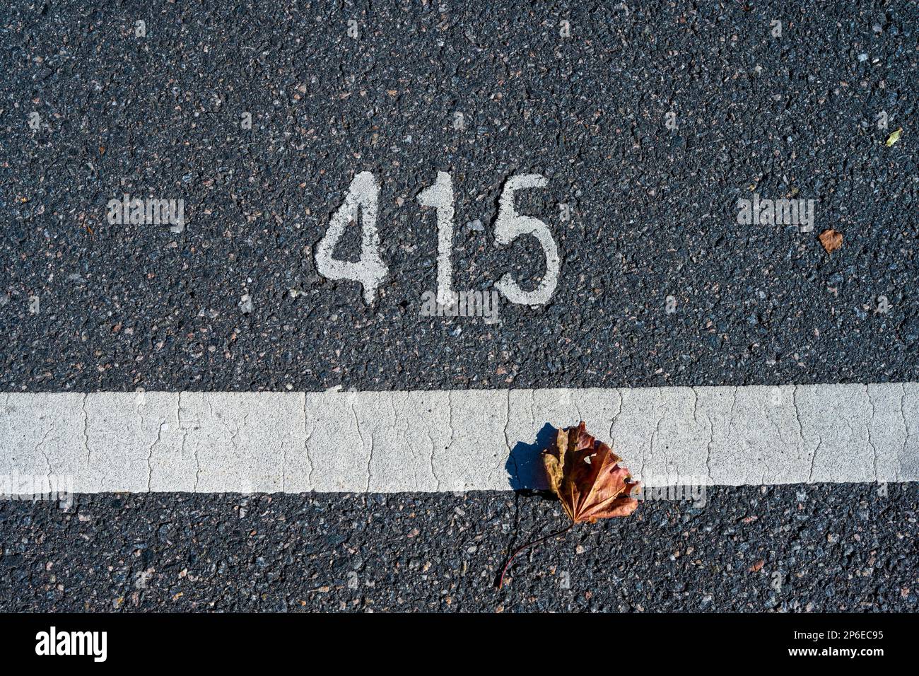 Asphalt with number 415 in white paint Stock Photo - Alamy
