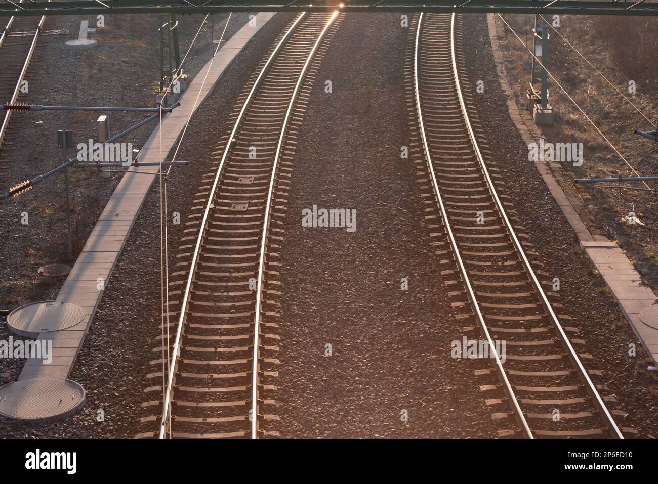 Double railway lines in low evening sun Stock Photo - Alamy