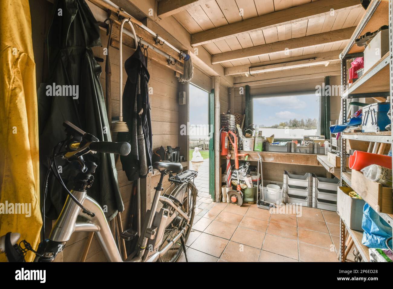 the inside of a house with bikes hanging on the wall and other things ...