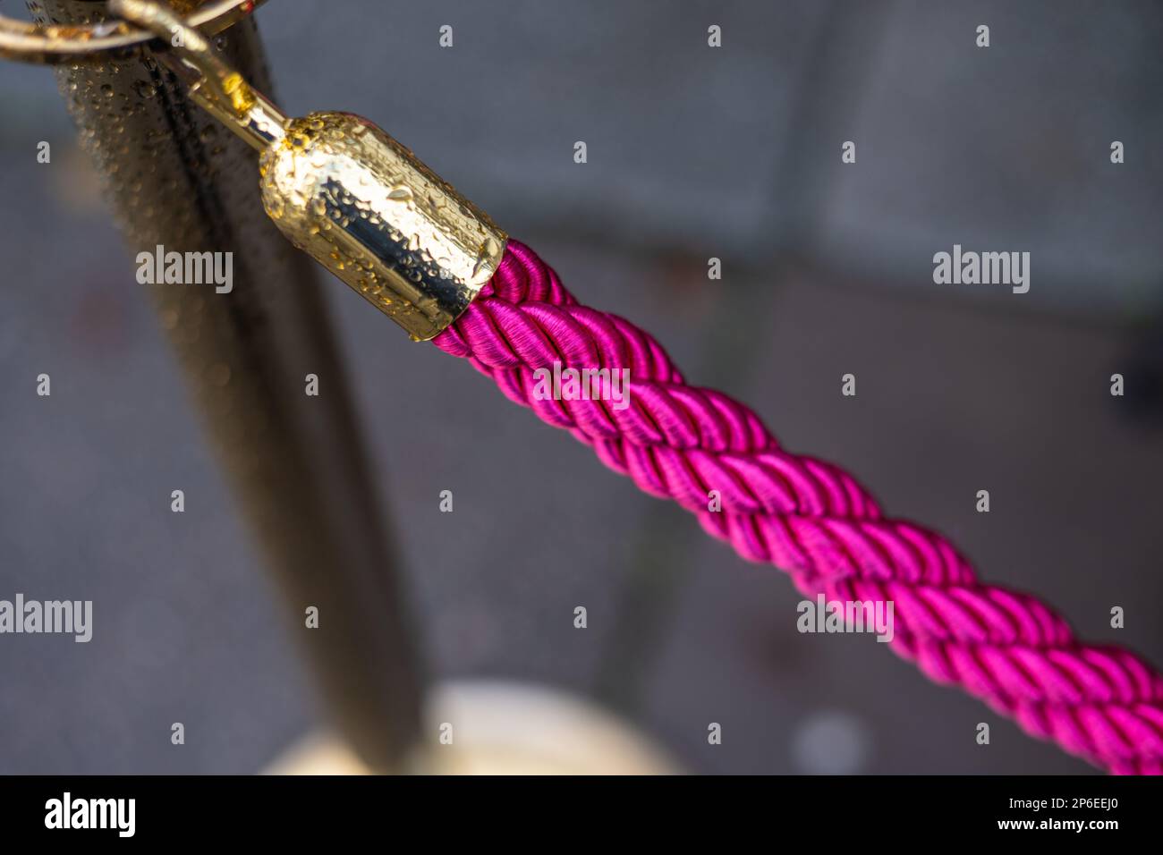 Bright pink rope on a golden pole Stock Photo - Alamy