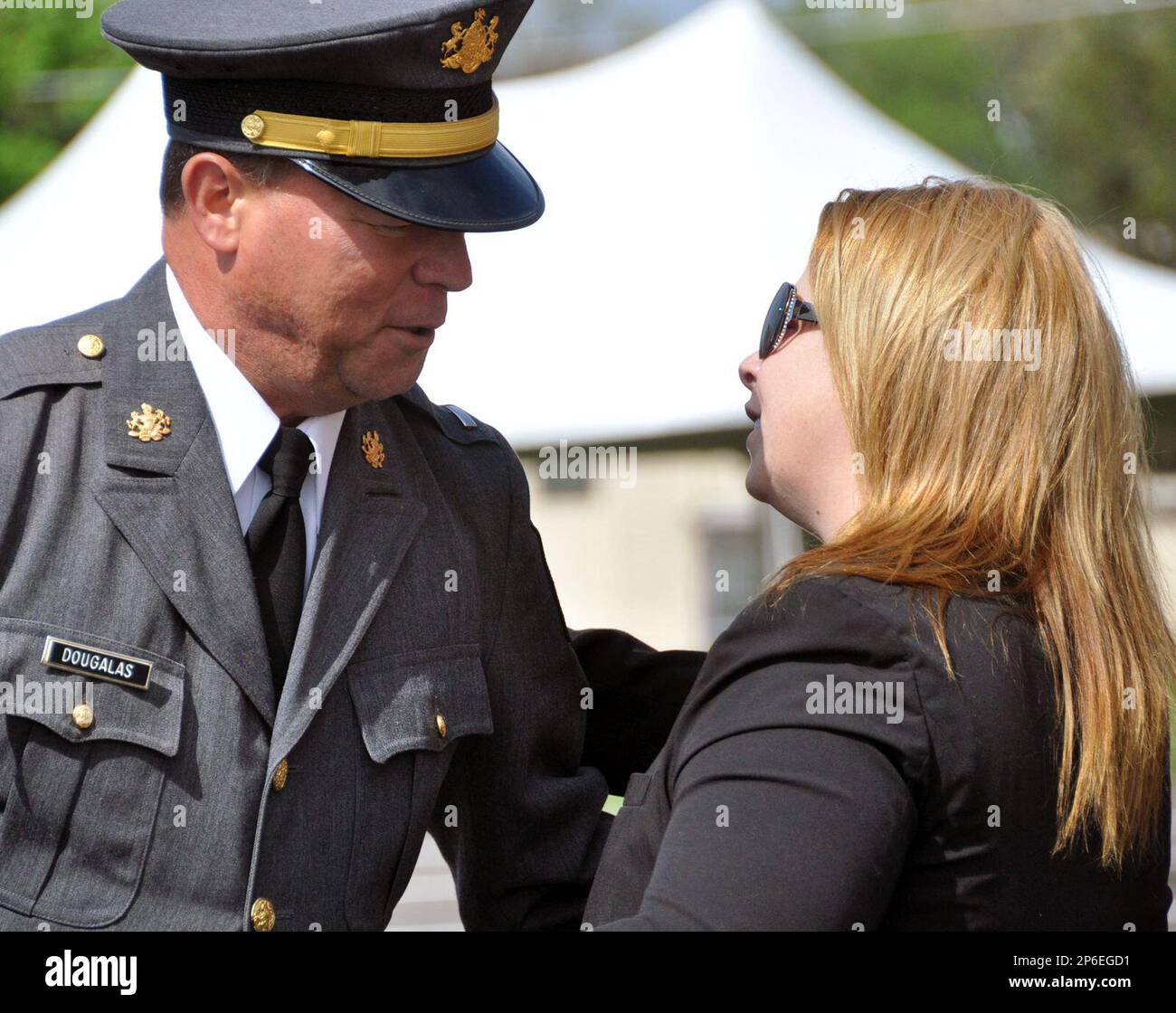 A trooper talks with Angela Miller, widow of Trooper Joshua Miller ...