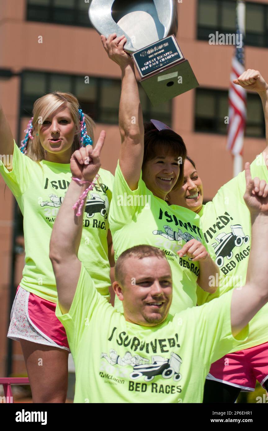 The winning team holds up their trophy at the end of the McLaren-Bay ...